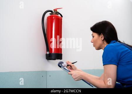 Safety Checking Fire Extinguisher. Emergency Prevention System Stock ...