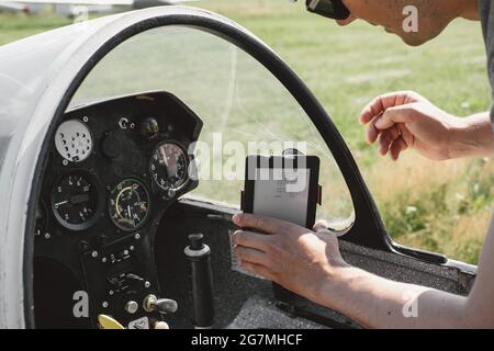 Pilot prepares for flight and checks the aerometric instruments ...