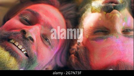 Beautiful shot of friends with colorful faces having fun at the ...