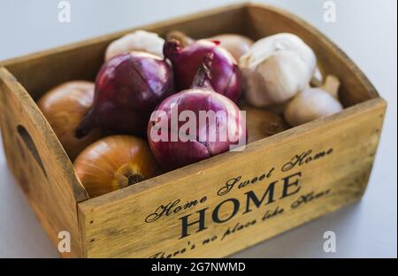 Photo of a container filled with onions and garlic Stock Photo - Alamy