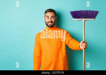 Boyfriend looking confused at broom, forced clean house, doing chores ...