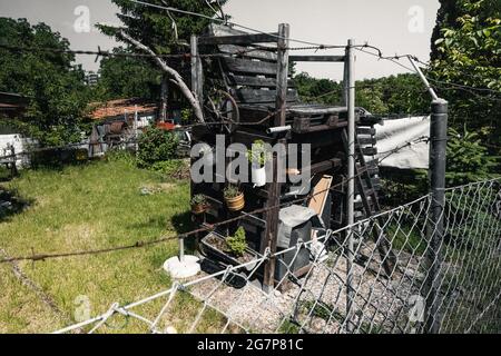 Wooden chair behind a barbed wire fence in the backyard Stock Photo - Alamy