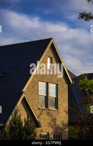 Rooftop of a house with attic windows under the blue sky Stock Photo ...