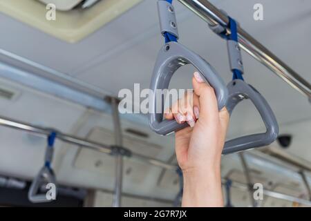 Women hand handle loop in the subway Stock Photo - Alamy