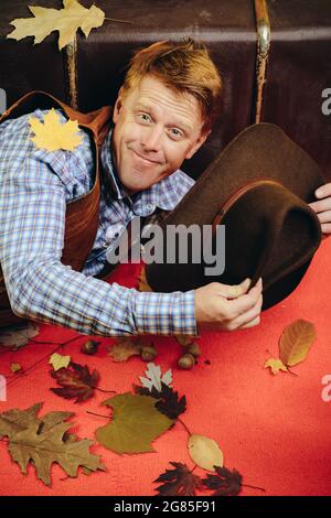 Having fun. A ginger man looking joyful and stretching his hand Stock ...