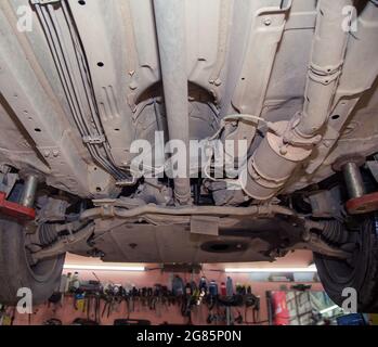Bottom view of the underbody of a car on a lift Stock Photo - Alamy