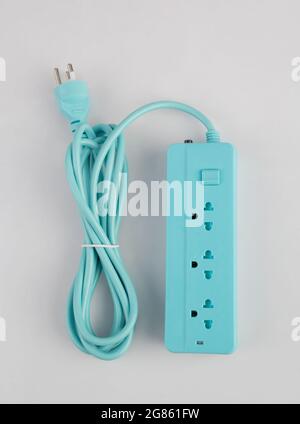 Four electrical sockets on a light wall and one electrical plug with a ...