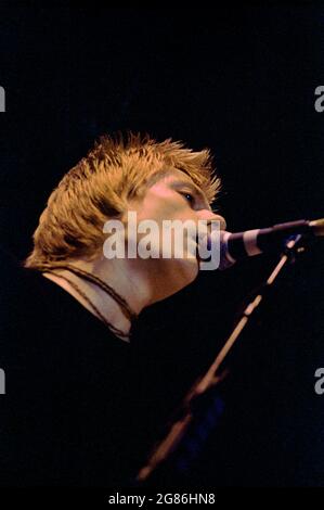 Crispian Mills from the band Kula Shaker performing on stage to a ...