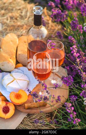 Wine in glasses. Picnic in the lavender field. Selective focus. Nature ...
