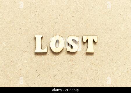 Wood letter in word lost on green grass background Stock Photo - Alamy