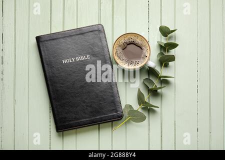 Holy Bible, cup of coffee and eucalyptus branch on wooden background ...