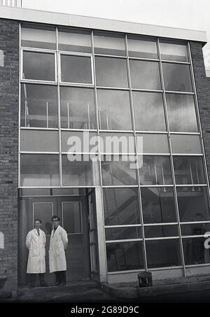 1960s, historical, two male window cleaners standing in a concrete pod ...