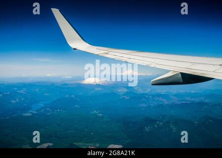 Airplane flying over the Cascade Mountains, near Mt. St. Helens and Mt ...