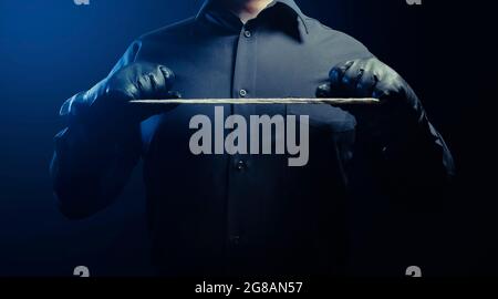 Photo of assassin killer man in black shirt and leather gloves ...