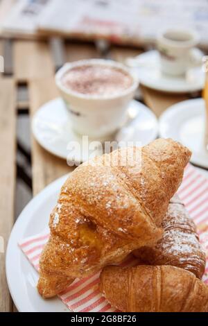 Typical italian breakfast with cappuccino, cornetto, espresso and ...