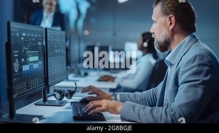 Portrait of Positive Professional Technical Controller Sitting at His ...