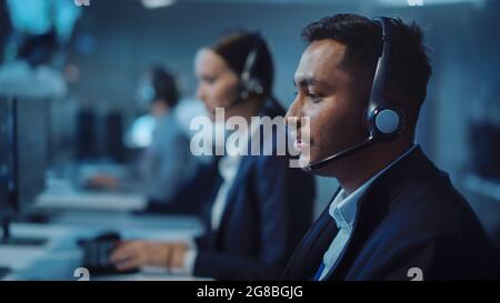 Portrait of joyful software developer in glasses programming on ...