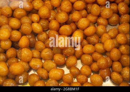Lokma are pastries made of deep fried dough soaked in syrup, chocolate ...