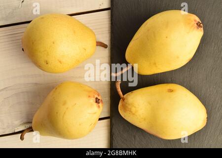 Four pears on a wooden board Stock Photo - Alamy