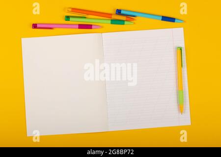 Colorful pens on a sheet of a notebook Stock Photo - Alamy
