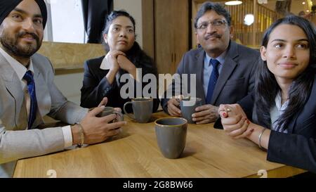Closeup shot of a group of Indian colleagues working in the office ...