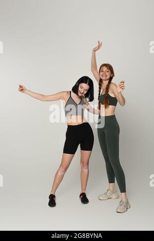 Young positive people dancing together slow ballroom dances in pairs ...