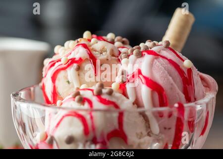 strawberry, banana and cream Roma ice cream in a glass bowl with red ...