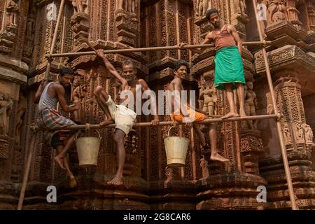 Group of men on scaffolding cleaning and restoring the ancient Rajarani ...