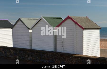 The rear of beach huts along the seafront at Goodrington Sands, with a ...