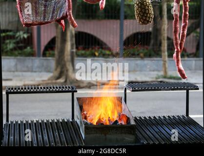 Argentine barbecue parrilla on the sidewalk in a street in Brazil. With ...