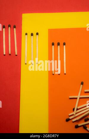 Top view of matchsticks arranged in groups of three on the red, yellow ...