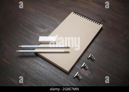 Blank kraft notepad, pencils and eraser on wood table background Stock ...