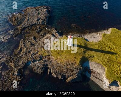 Lighthouse and coastal landscape with basalt formations, Kalfshamarsvik ...