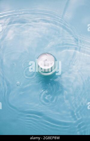 Cosmetic products in water splashes on gray background Stock Photo - Alamy
