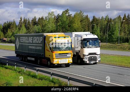 Two white DAF XF heavy trucks, 2021 generation vehicle left and ...