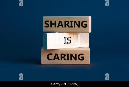 Sharing is caring symbol. Concept words 'Sharing is caring' on wooden ...