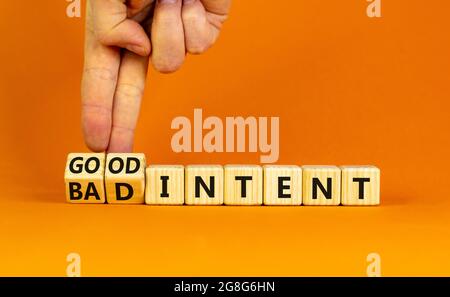 Good or bad intent symbol. Businessman turns wooden cubes and changes ...