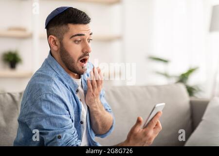 Shocked israeli man using his mobile phone Stock Photo - Alamy