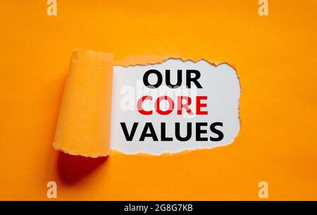Our core values symbol. Words 'Our core values' appearing behind torn ...