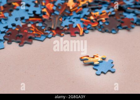 Colorful Peaces of a Mixed Jigsaw Puzzle Lie on the Wooden Table ...