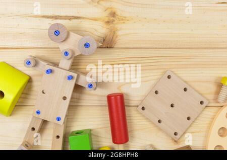 A colorful wooden building kit for children on wood. Set of tools on ...