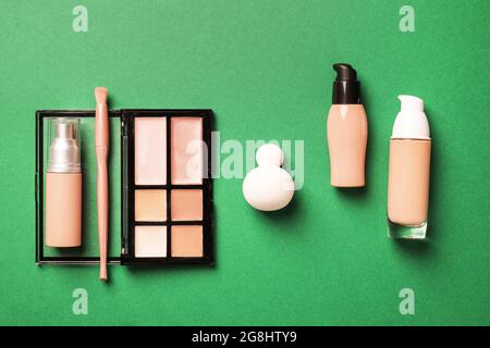 Makeup sponge with tonal foundation and blusher on color background ...