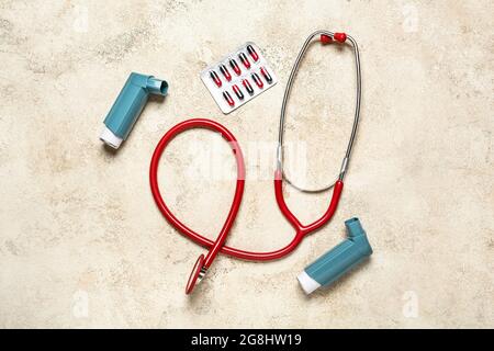 Modern inhalers, pills and stethoscope on grunge background Stock Photo ...