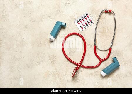 Modern inhalers, pills and stethoscope on grunge background Stock Photo ...