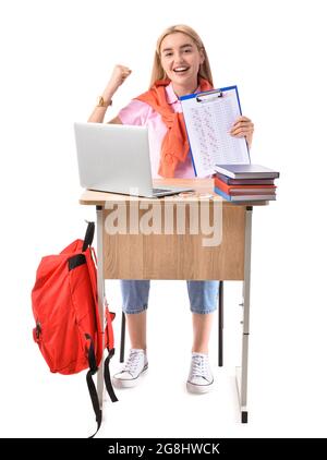 Happy female student with answer sheet after exam in classroom Stock ...