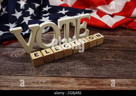 Vote Election Word alphabet letters with USA flag on wooden background ...