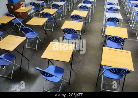 english school hall full of lines of chairs and tables for examinations ...
