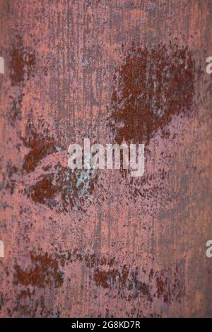 A rusty metal surface with a blue and brown color. The surface has a ...