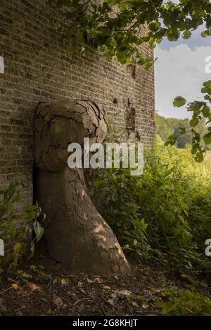 Remains of typical Dutch brick windmill overgrown with greenery Stock ...