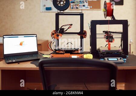 Desk with computer and chair located near glass door in spacious living ...